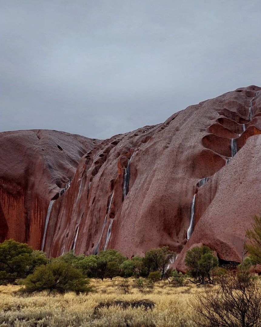 Waterfalls on Uluru after outback soaking, more rain to come